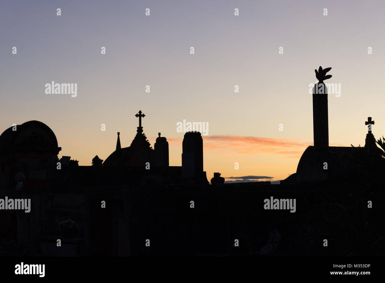The silhouette of Roussillon's cemetery at sunset. Crosses, spires ...