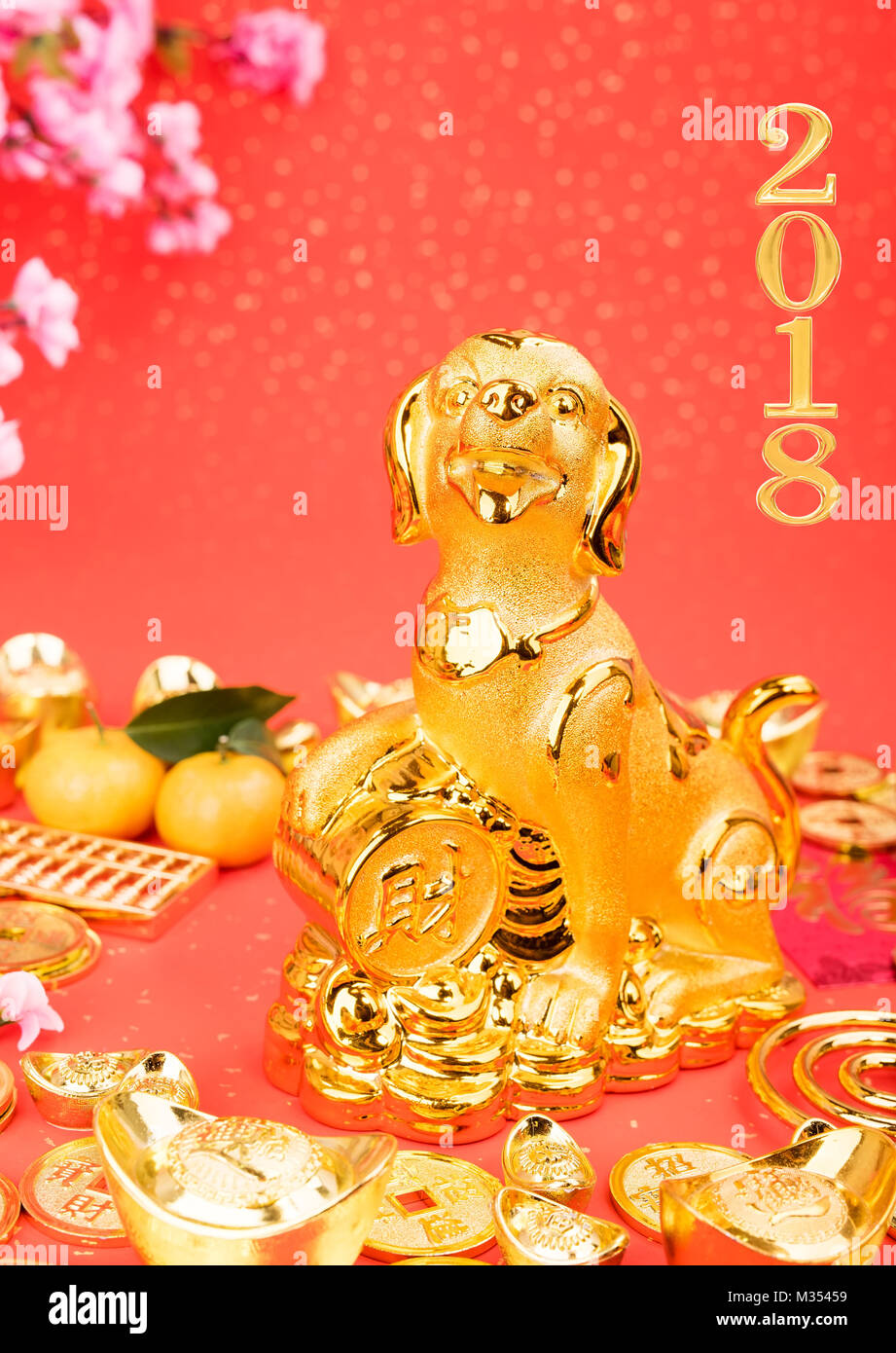 golden dog statue on red paper,translation of calligraphy: good Fortune ...