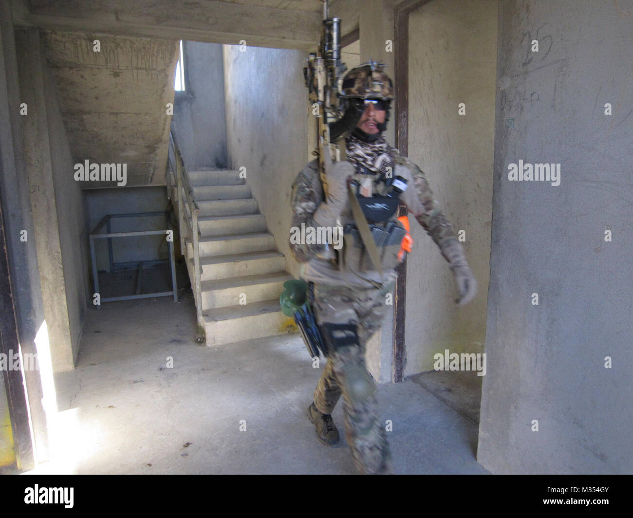 A Crisis Response Unit 222 operator departs a cleared building during a ...