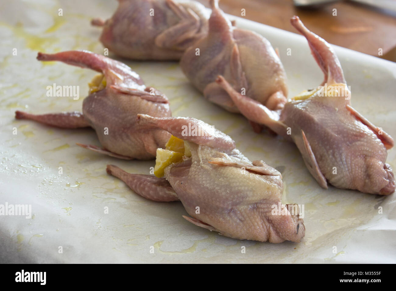 A raw quail stuffed with fresh fruits and vegetables on tray Stock ...