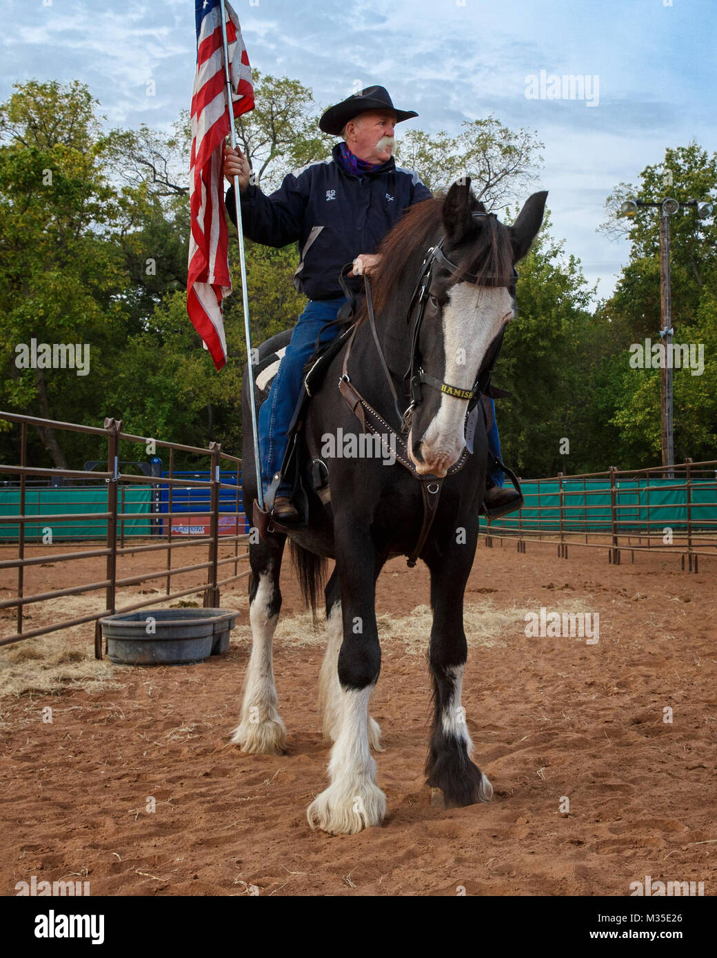 Doug Sauter of Express Ranches pays respect to the flag during the ...