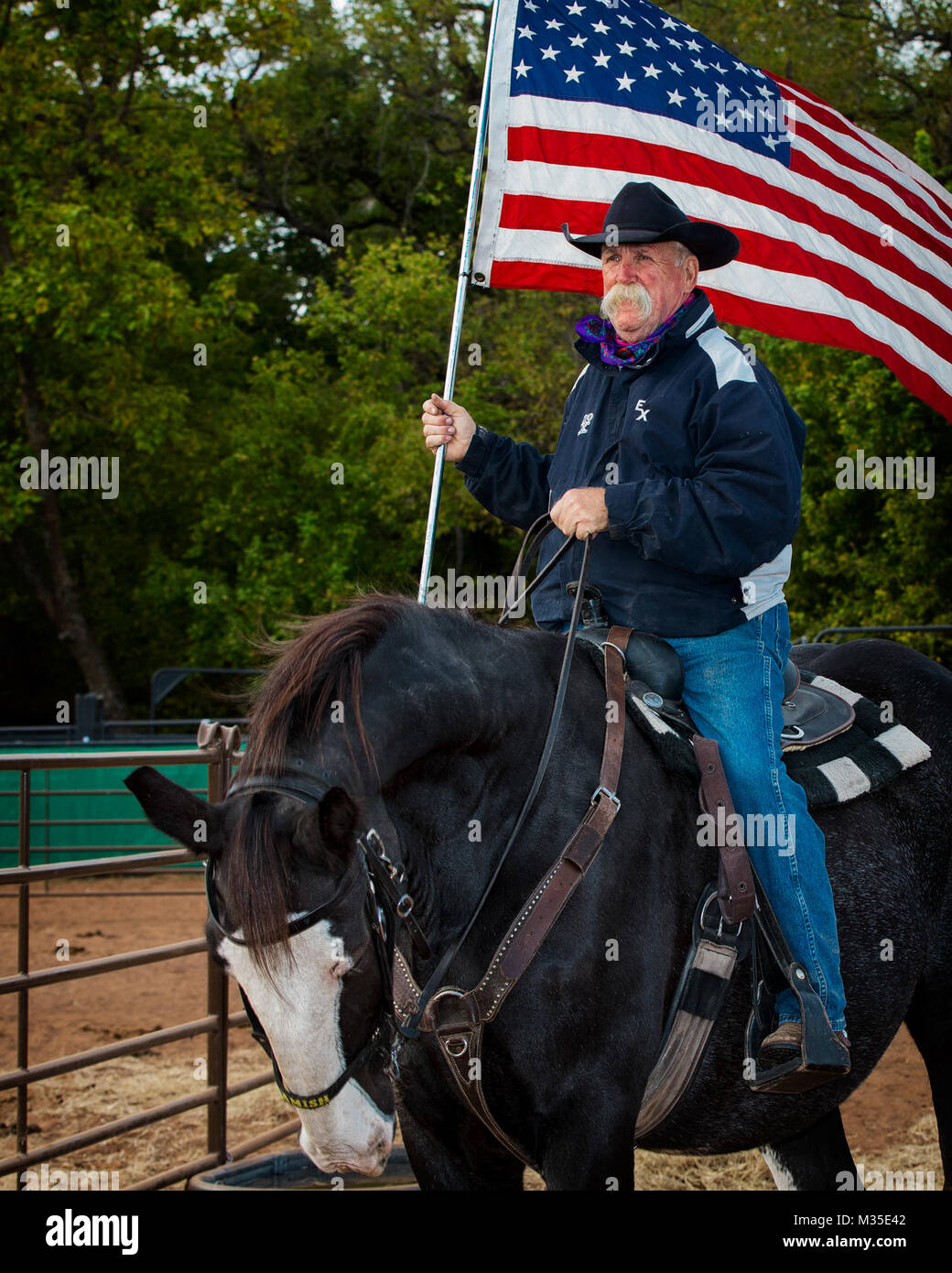 Doug Sauter of Express Ranches pays respect to the flag during the ...