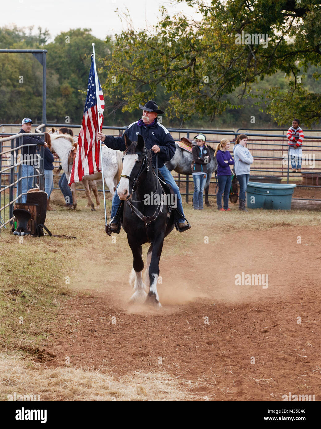 Doug Sauter of Express Ranches pays respect to the flag during the ...