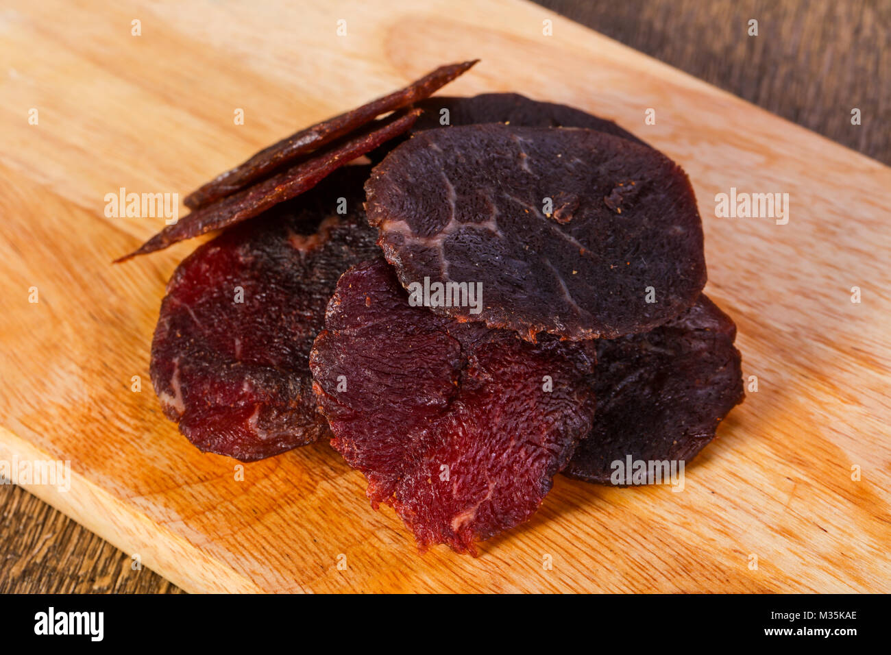Dry beef meat over wooden Stock Photo - Alamy