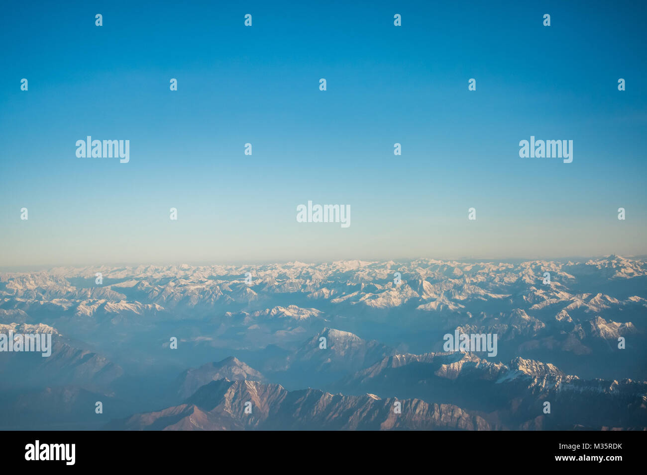 Looking through the window aircraft during flight a snow covered ...