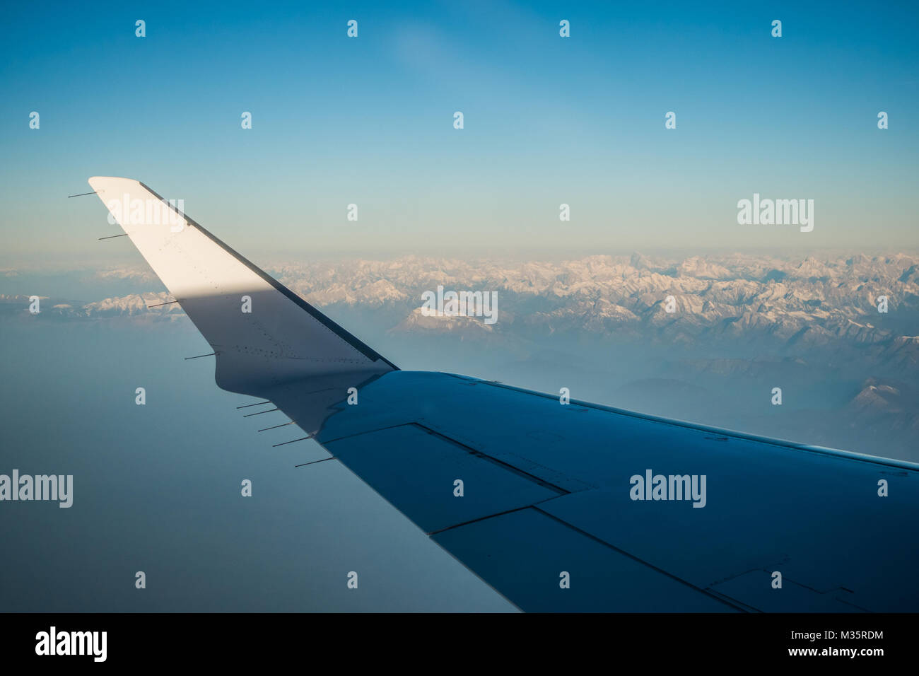 Looking through the window aircraft during flight a snow covered ...
