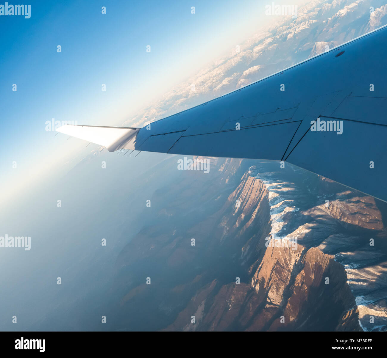 Looking through the window aircraft during flight a snow covered ...