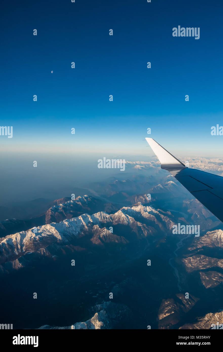 Aerial snow covered alps through airplane hi-res stock photography and ...