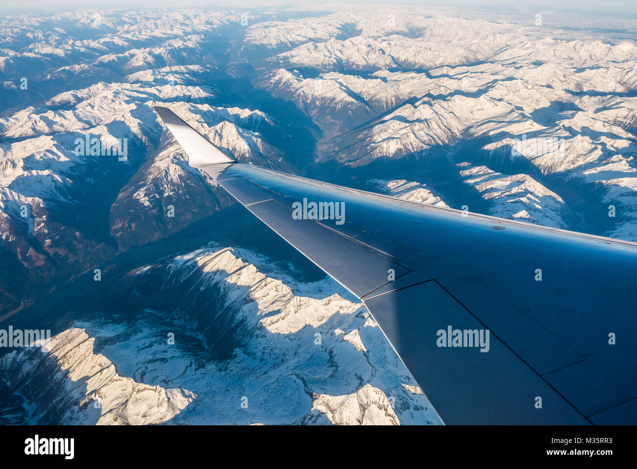 Looking through the window aircraft during flight a snow covered ...