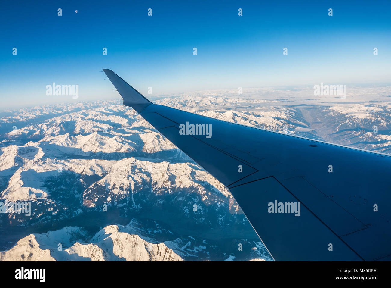 Looking through the window aircraft during flight a snow covered ...