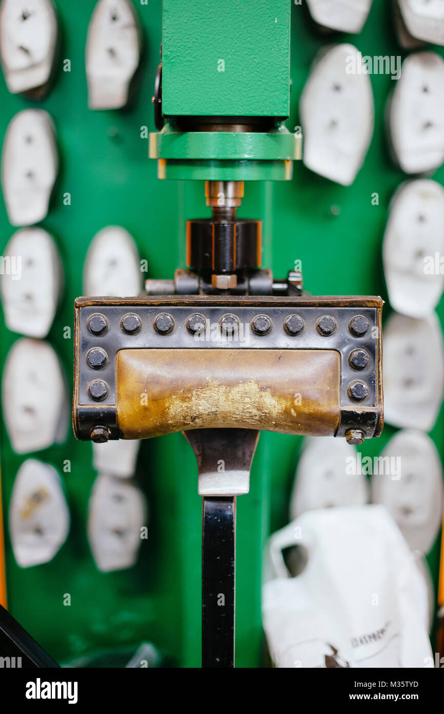 workshop shop shoemaker machine to reshoke shoes Stock Photo - Alamy