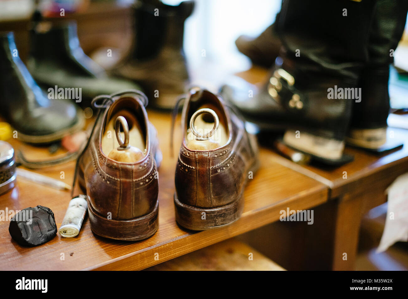 interior repair shop and shoe making, shoemaker workbench with shoes in ...