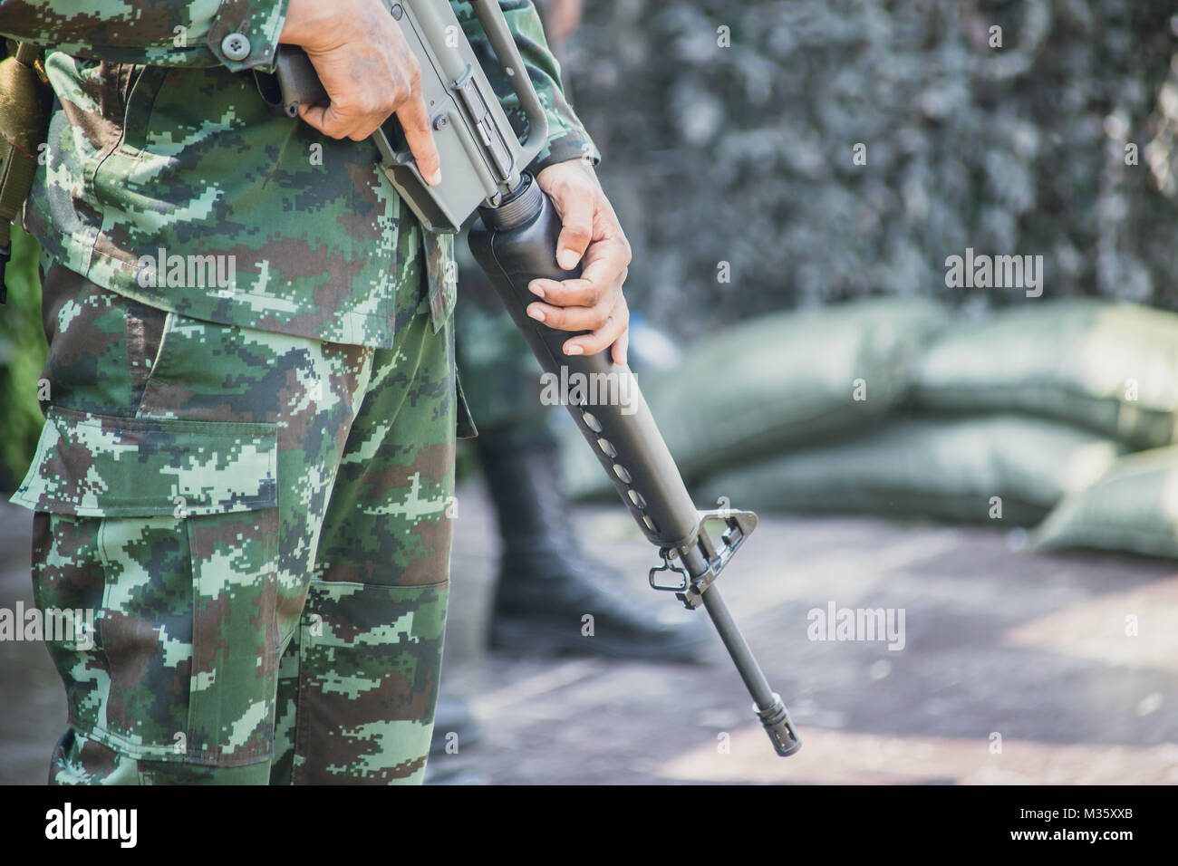 soldier with Colt M16 gun stand guard to security military camp Stock ...
