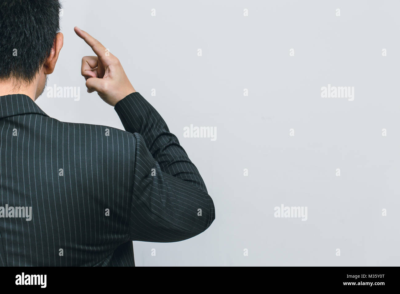 Asian business man finger at head for use his brain to thinks clever ...