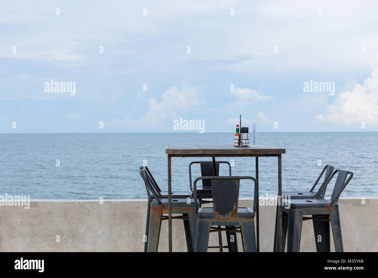 simple dinner table sea side ocean view nobody Stock Photo - Alamy