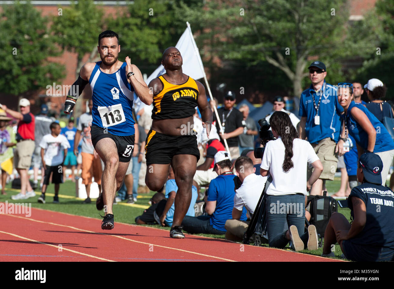 Veteran Staff Sgt. Ryan Crane (left) competes in the 100-YD dash during ...
