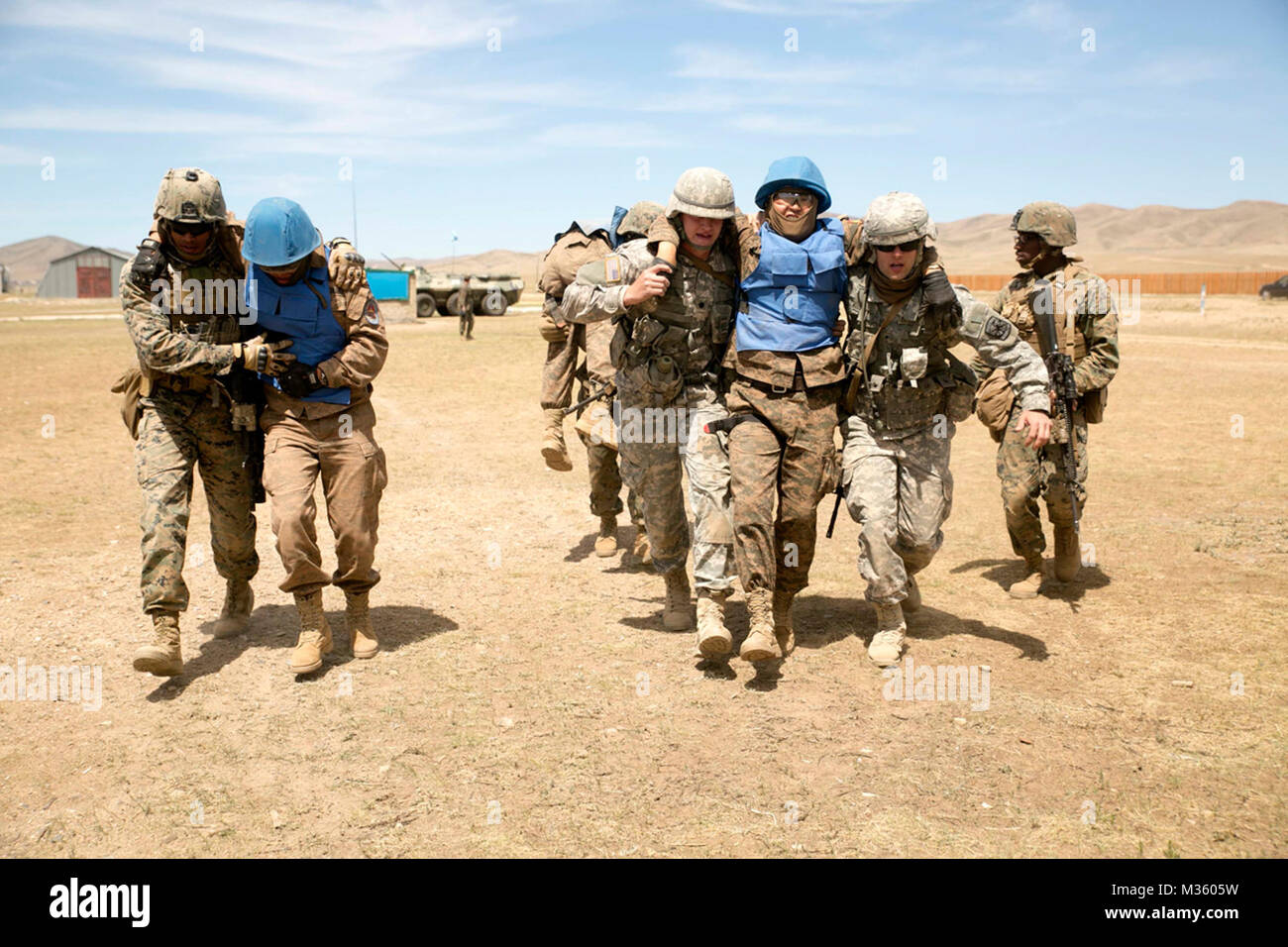 U.S. Marines and U.S. Army cadets carry simulated casualties to a safe ...
