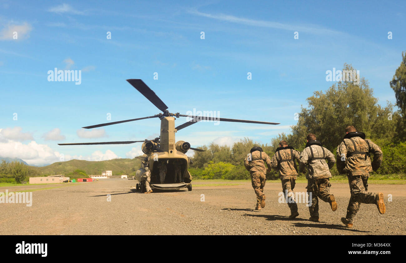 Combat engineers move to a UH-47 aircraft to begin a helocast operation ...
