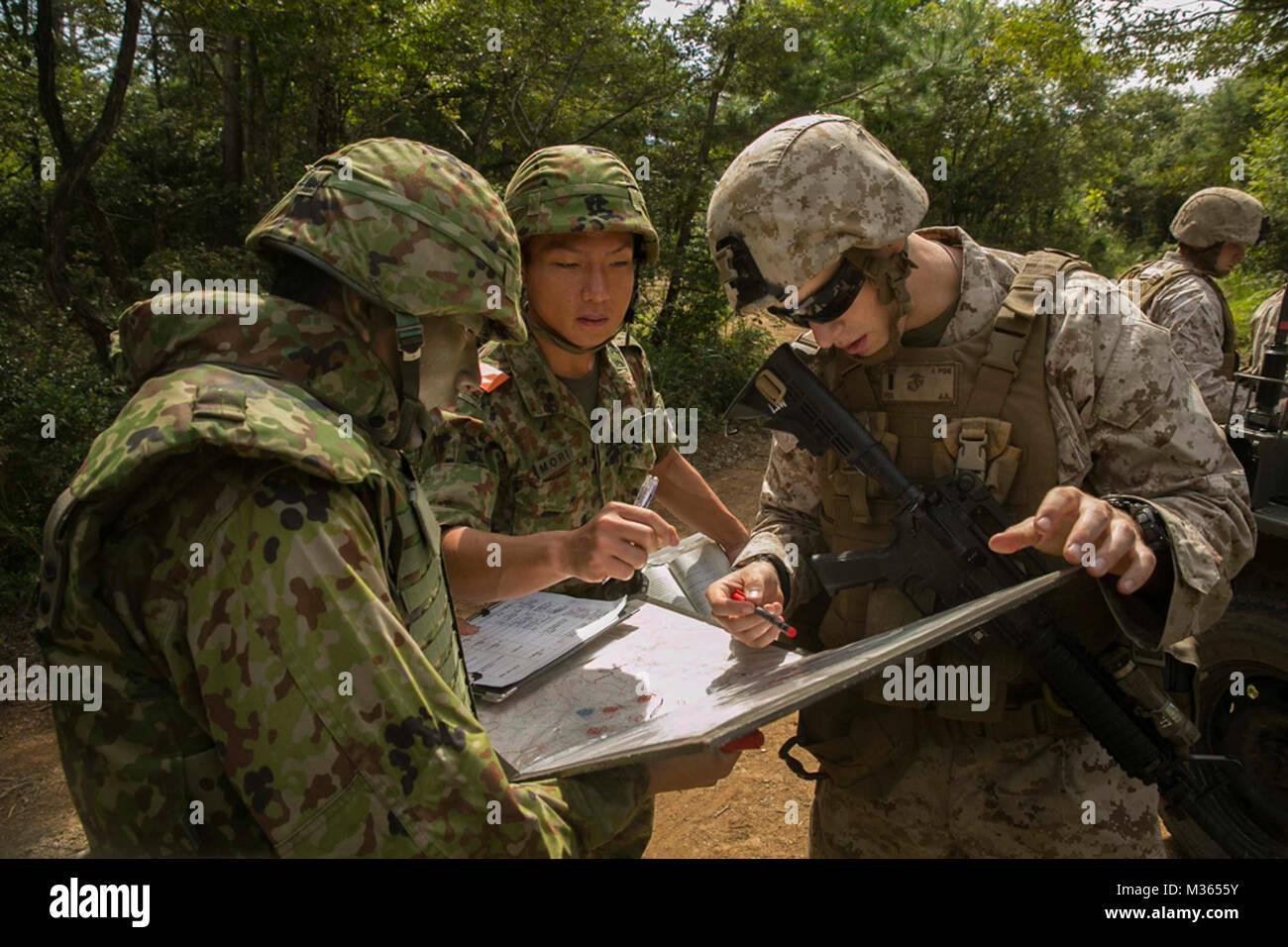 U.S. Marine 1st Lt. Jake Fox, right, highlights the first objective of ...
