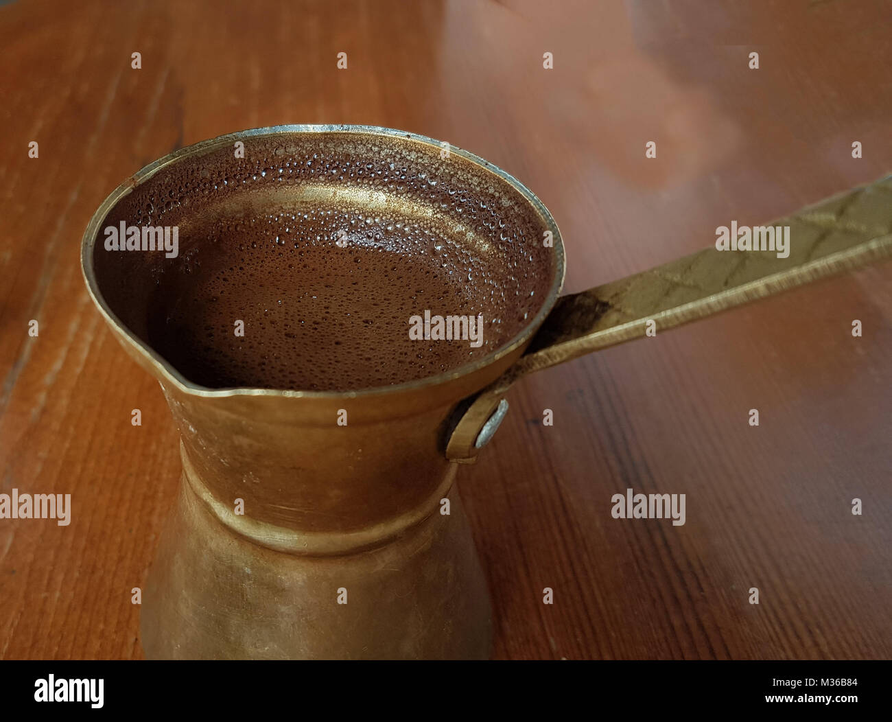 coffee turkish greek style hot in "briki" , hot bubbles Stock Photo - Alamy