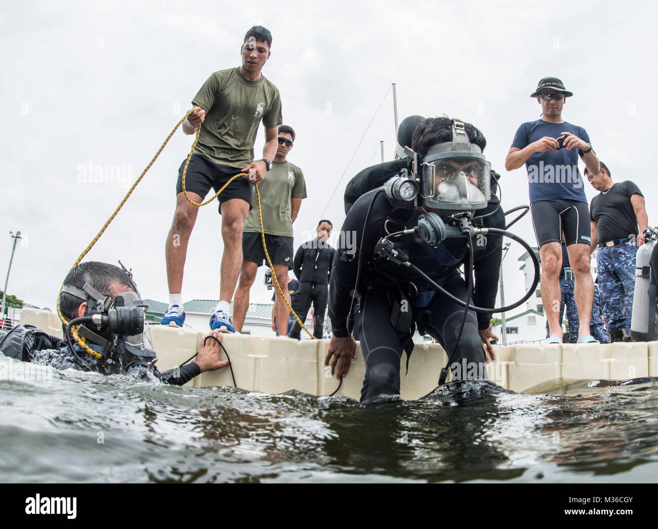 An Indian Explosive Ordnance Disposal (EOD) technician enters the water ...