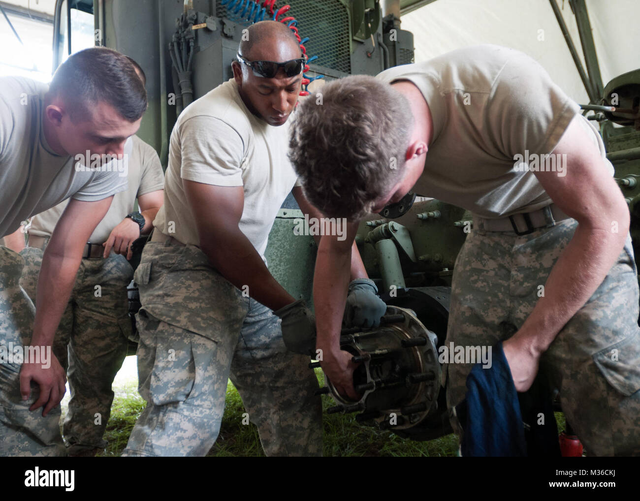 Soldiers from the 655th Transportation Company, provide maintenance to ...