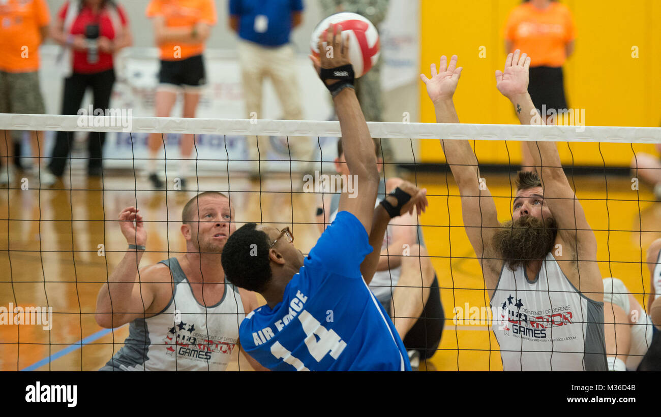 Air Force veteran Trent Smith, center, hits the ball past SOCOM ...
