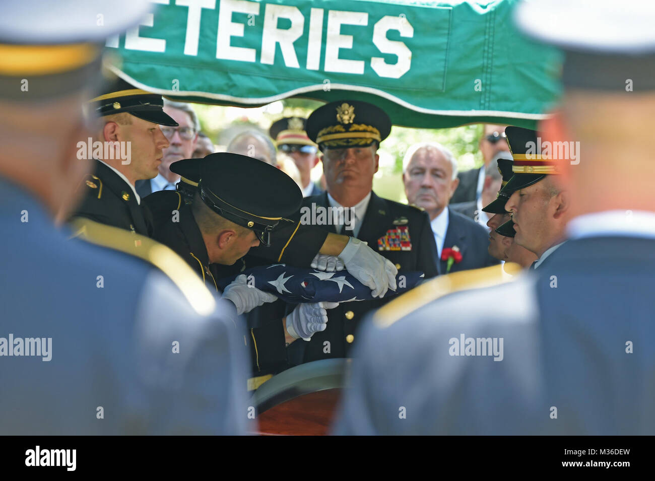 Military honor guard passes the American Flag to Maj. Gen. Glenn H ...