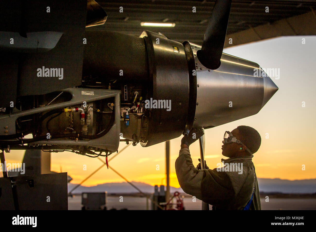 Airman 1st Class James Spence, an MQ-9 crew chief, uses his radio to ...