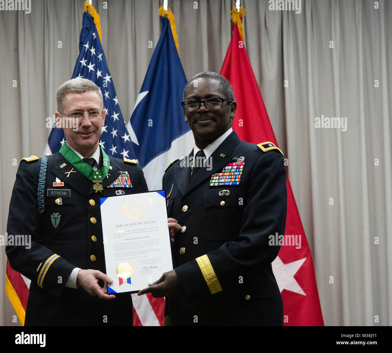 Col. Joachim Strenk is presented with his retirement certificate by Maj ...