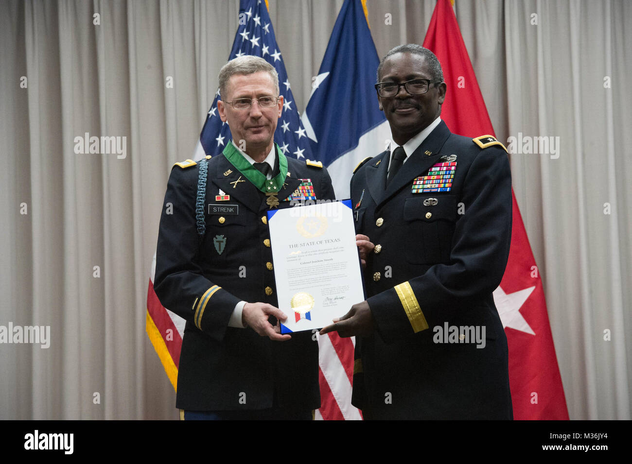 Col. Joachim Strenk is presented with his retirement certificate by Maj ...