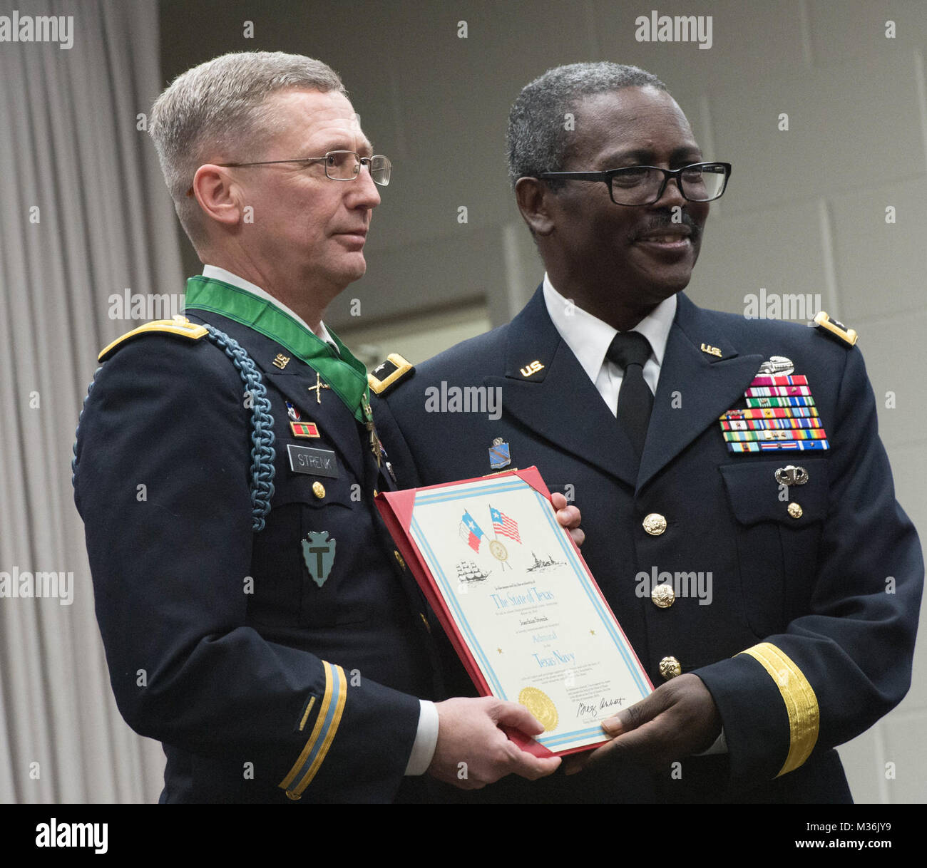 Col. Joachim Strenk is presented with a certificate recognizing him as ...