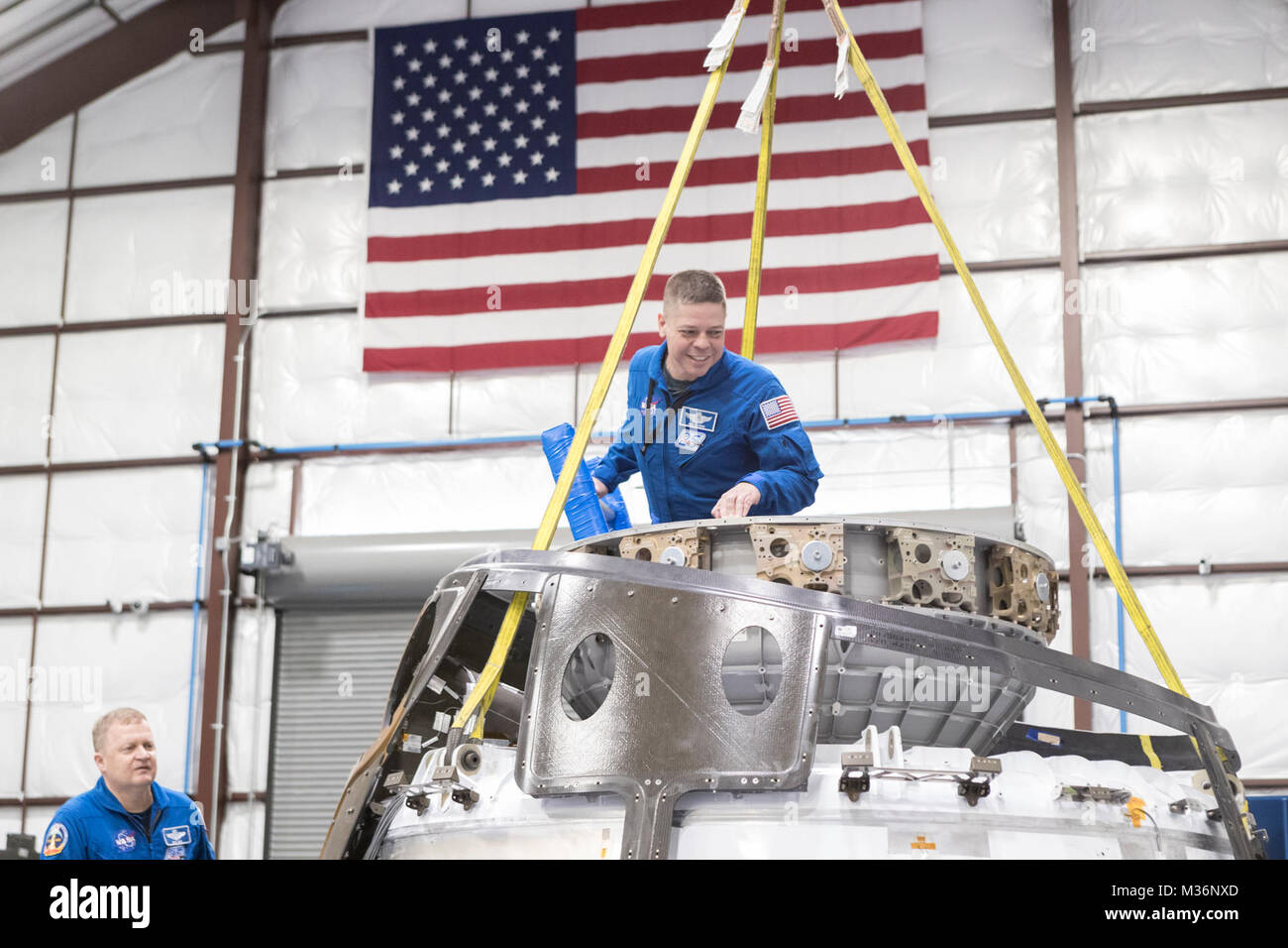 Astronaut USAF Col. Bob Behnken emerges from the top hatch of a SpaceX ...