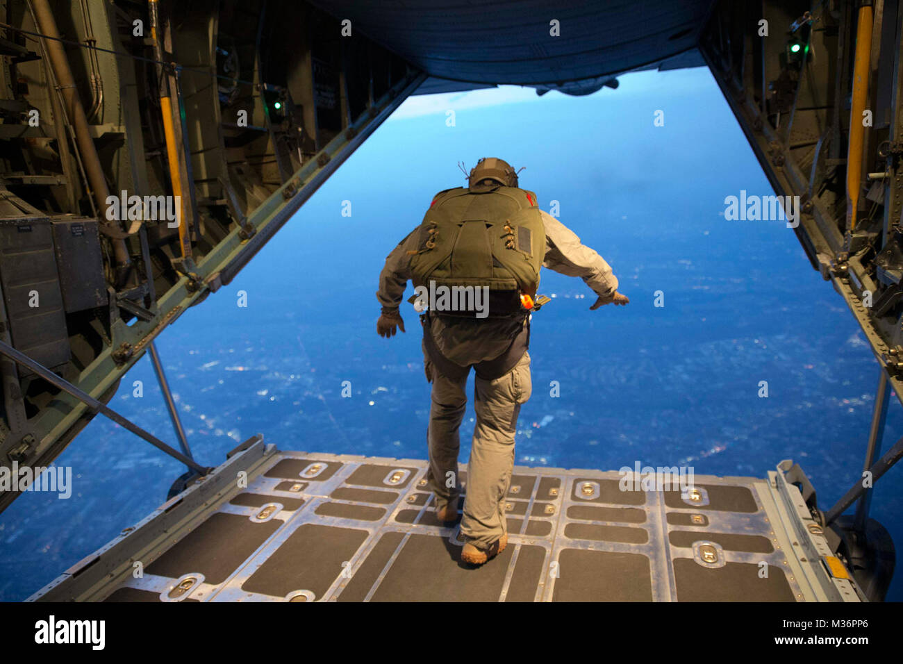 A U.S. Marine conducts high altitude – low opening jump from the back ...