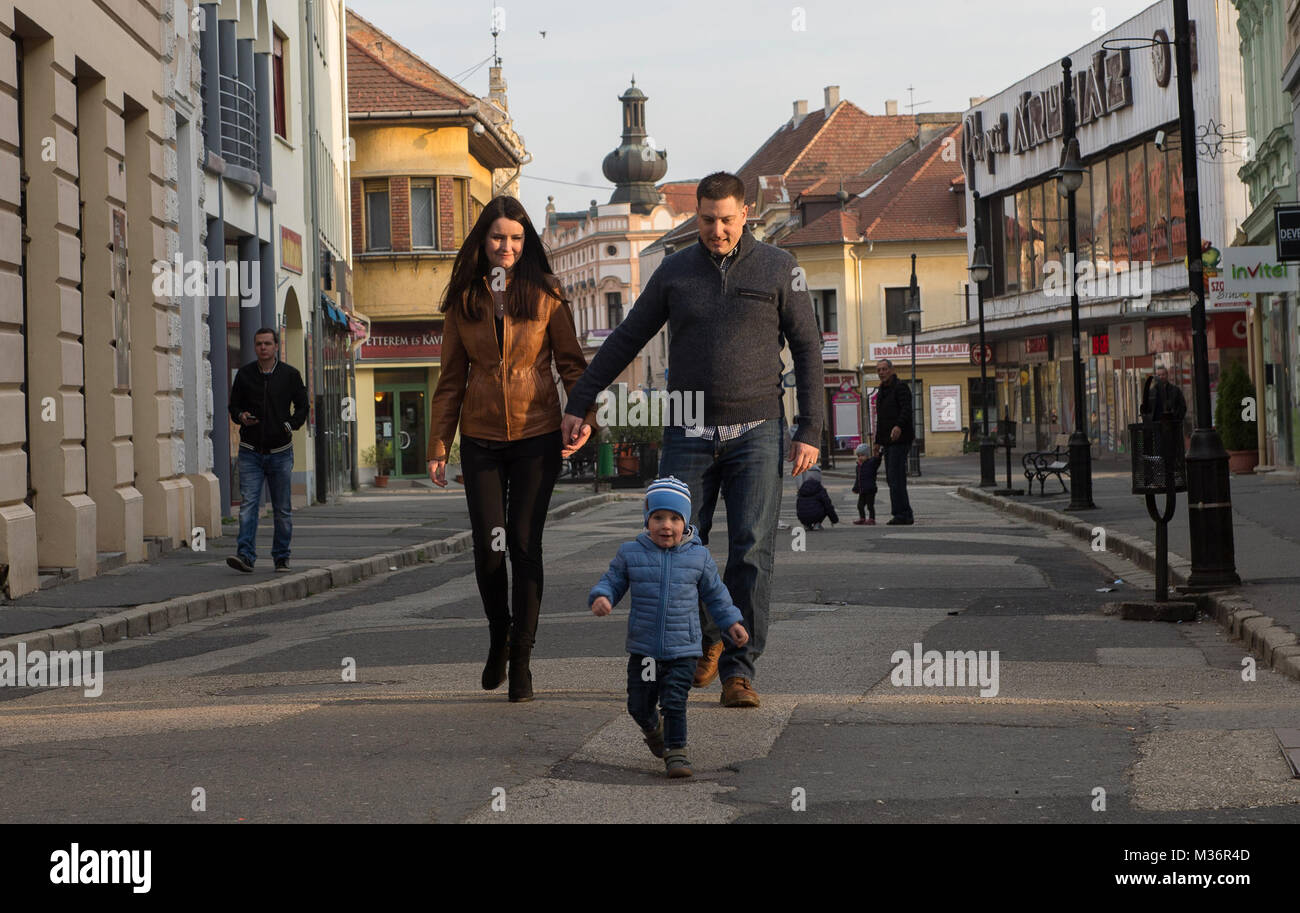 Master Sgt. Brandon Nicely and his family walk down a walking street in ...