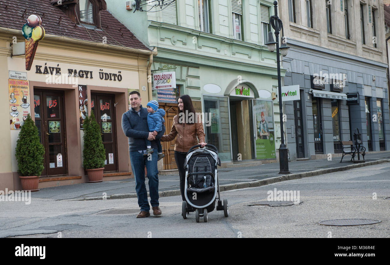 Master Sgt. Brandon Nicely and his family walk down a street in ...