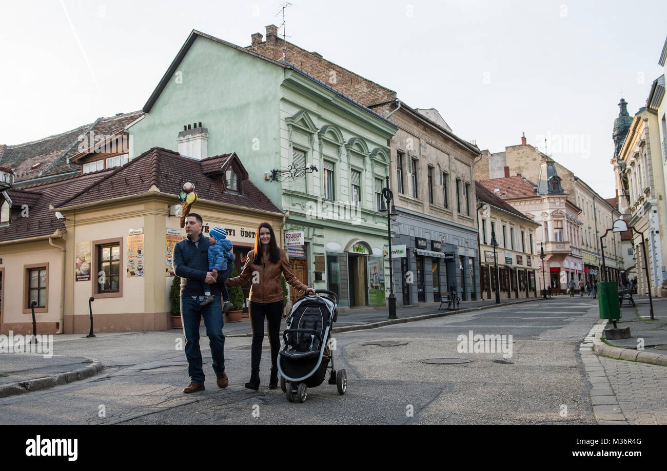 Master Sgt. Brandon Nicely and his family walk down a street in ...