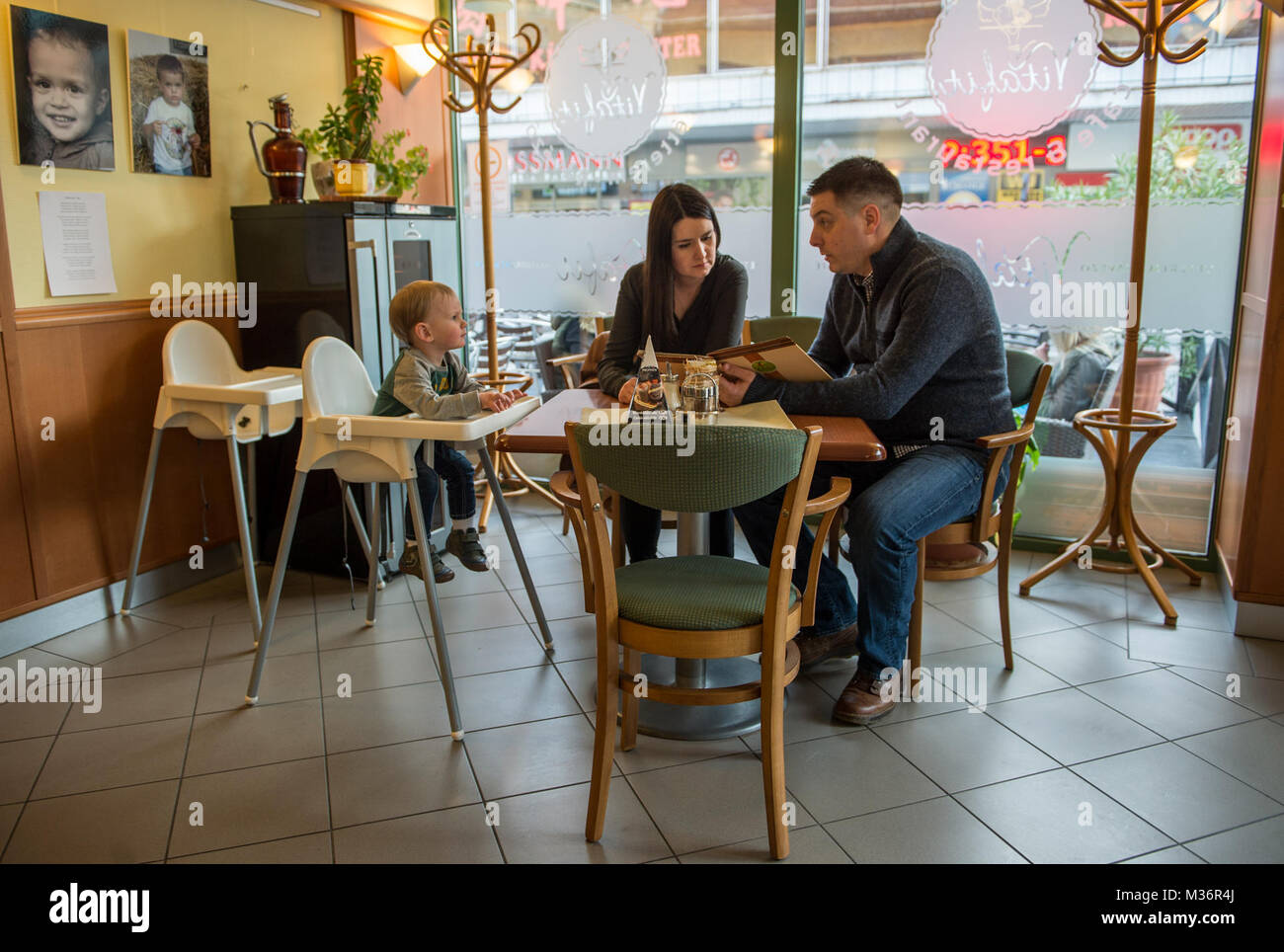 Master Sgt. Brandon Nicely and his family look at a menu in a downtown ...