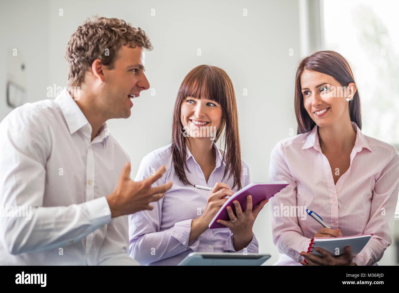 Confident female worker writing hi-res stock photography and images - Alamy