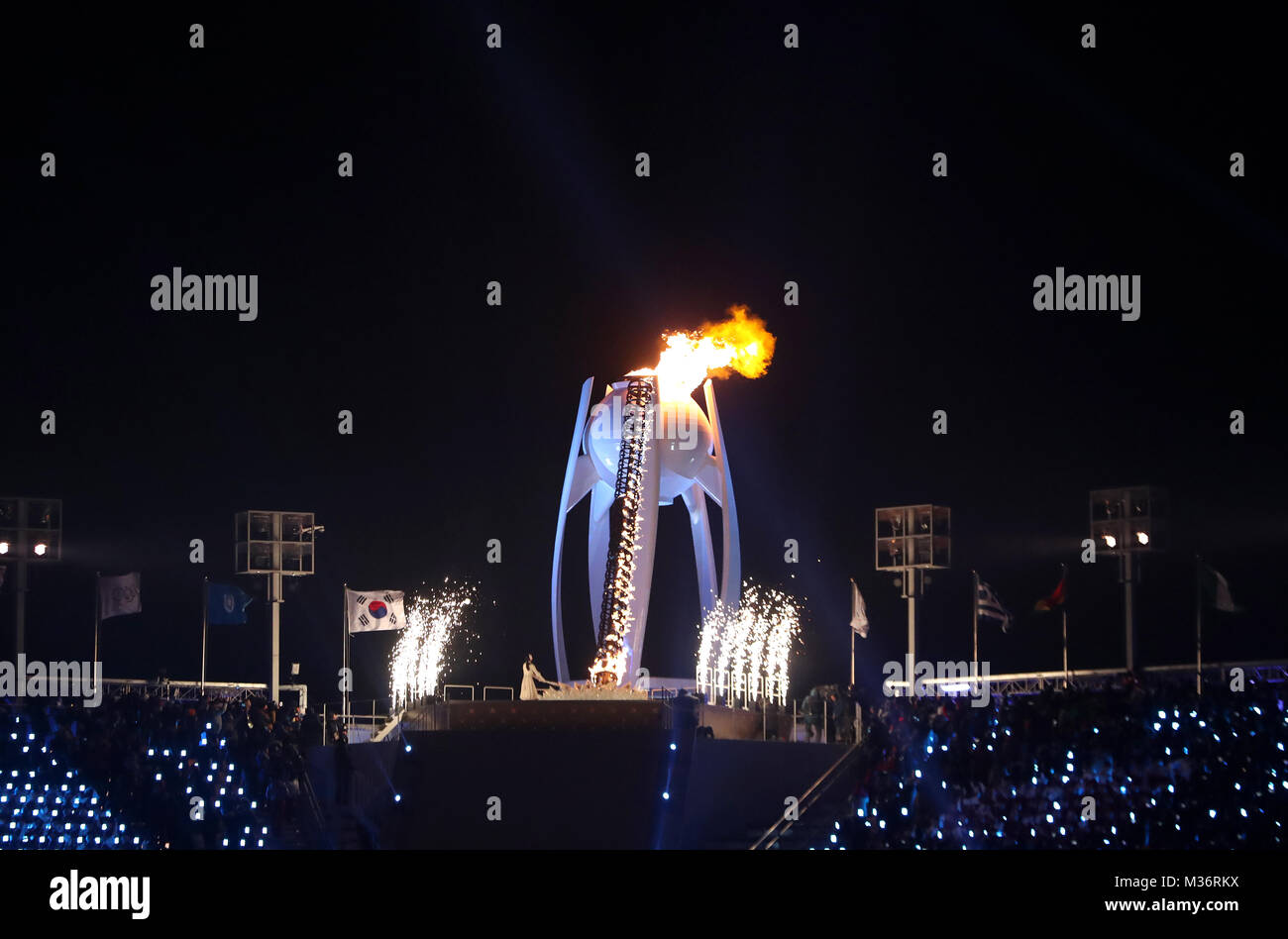 Fireworks are aset off as the Olympic torch is lit during the Opening ...