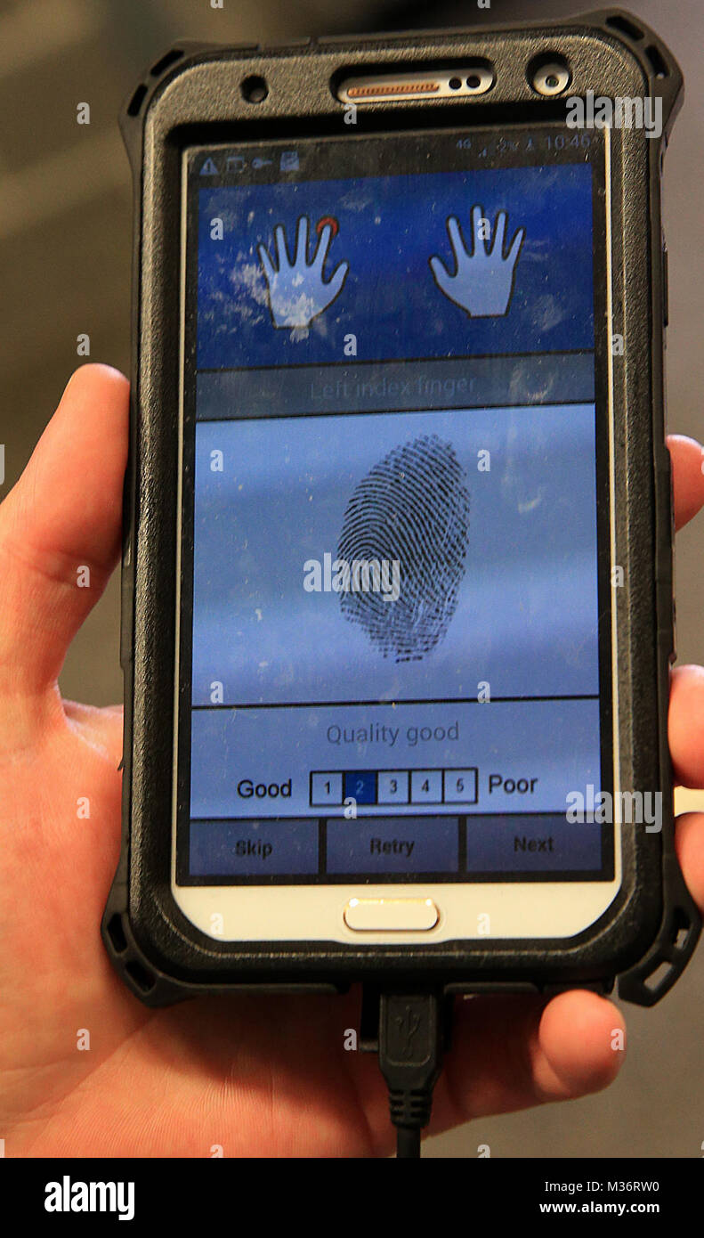 A West Yorkshire Police officer holding a new mobile fingerprint ...