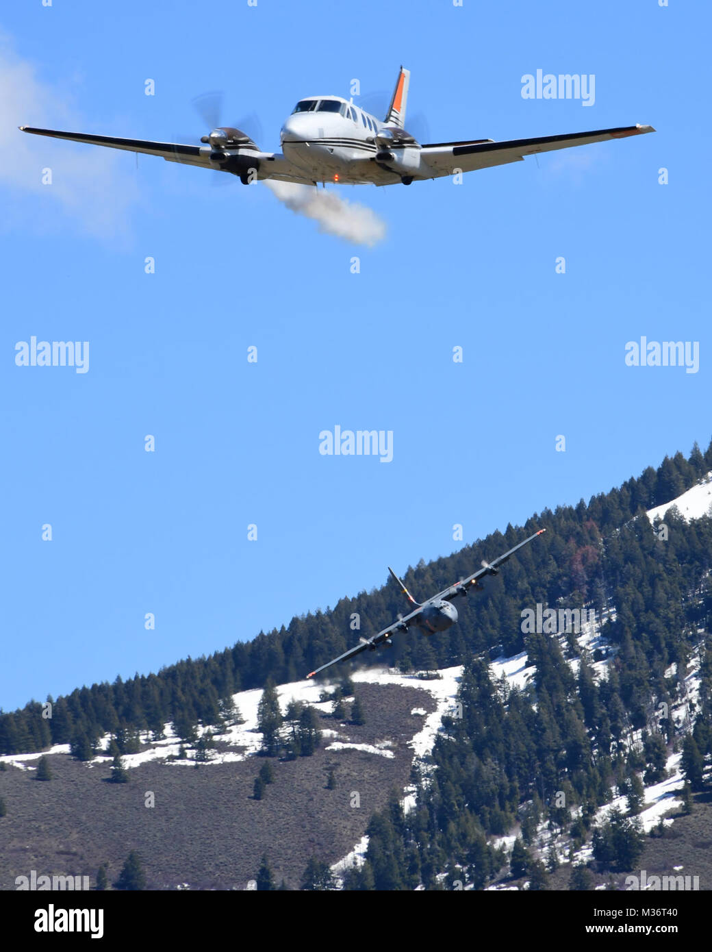 A U.S Forest Service Lead Plane leaves a trail of white smoke to ...