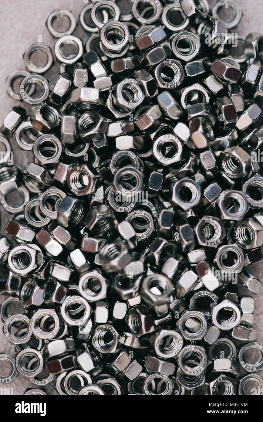 Industrial metal nuts background, close up view Stock Photo - Alamy