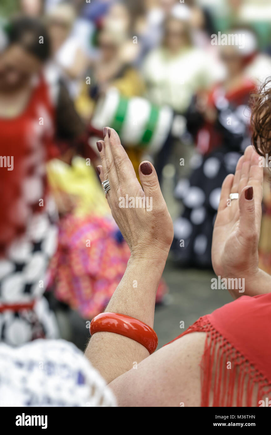 Spanish woman dressed in flamenco, dancing and clapping her hands in ...