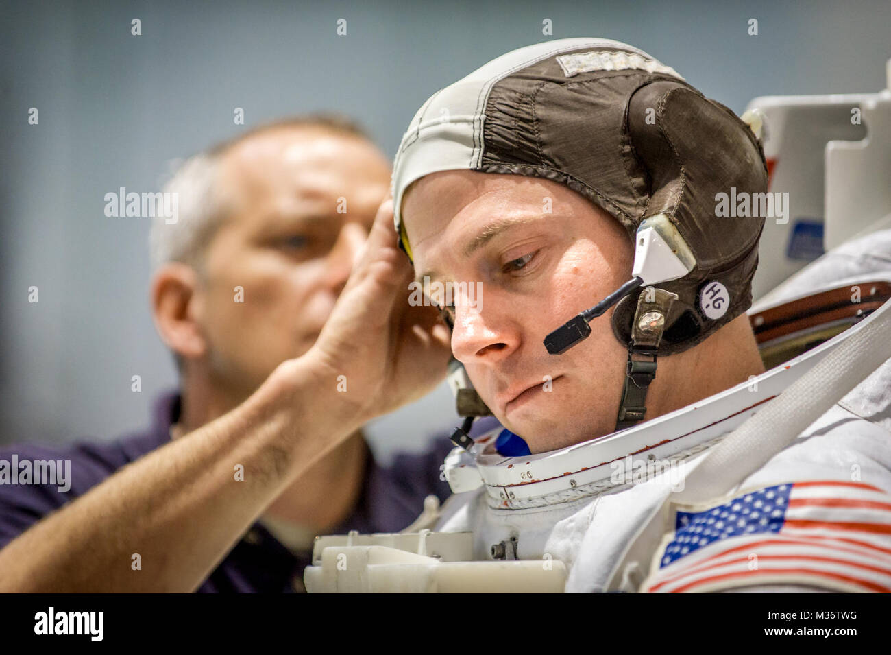 Canadian Space Agency astronaut David Saint Jacques helps Astronaut Col ...