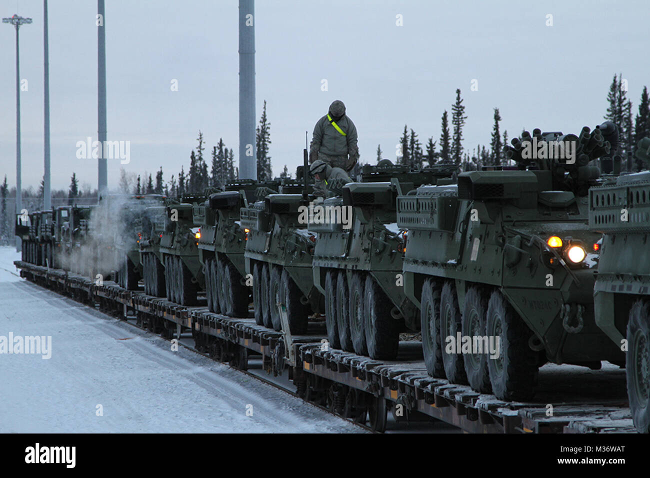 Strykers and other vehicles wait to be driven off train cars at Fort ...