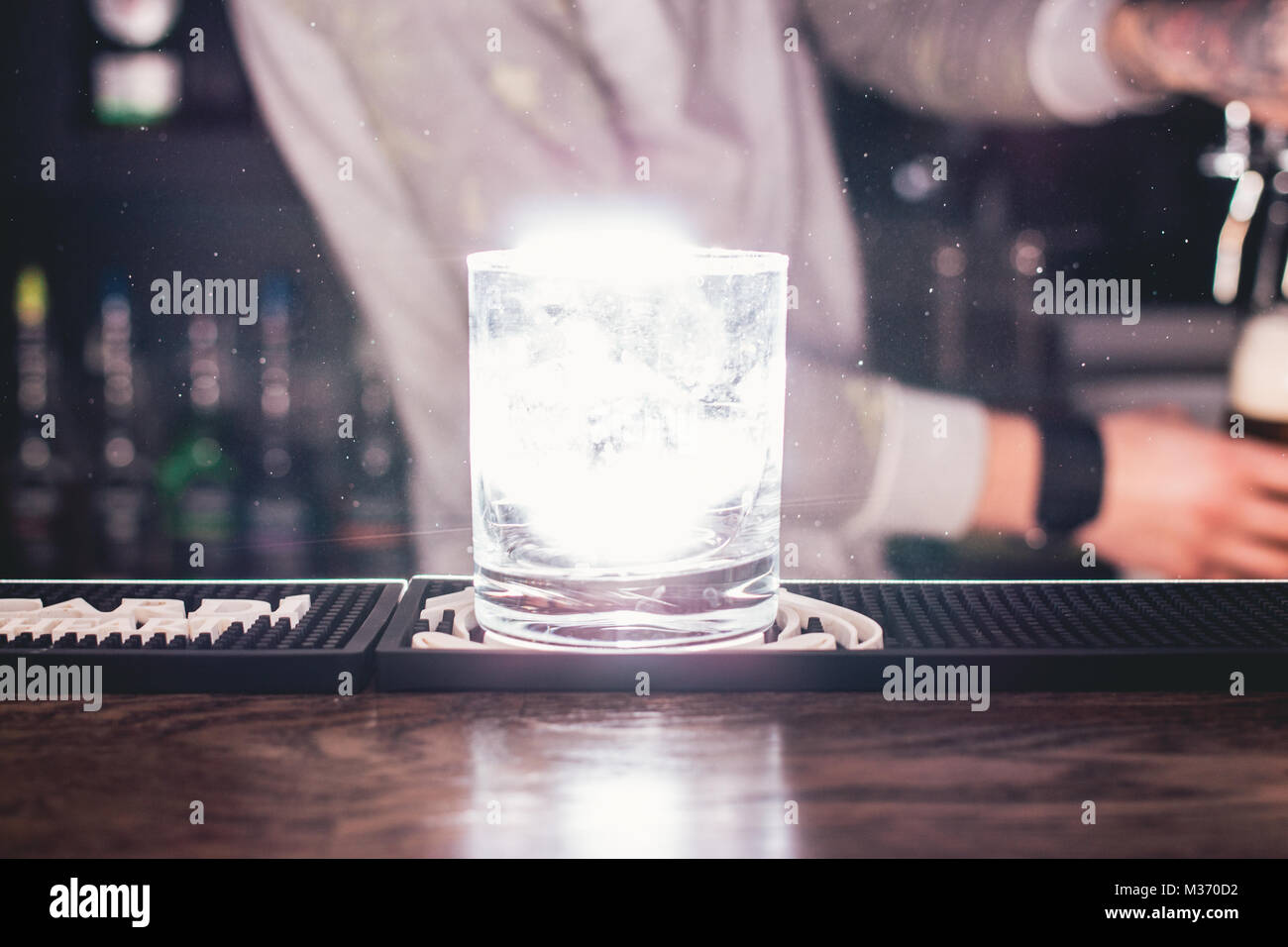 Luminous glass with alcohol cocktail on the bar Stock Photo - Alamy