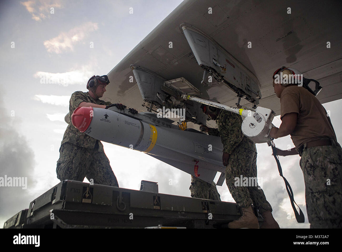 Missiles are loaded onto P-3 to conduct sink exercise during Valiant ...