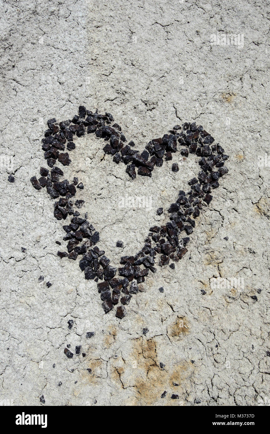 stone heart made of red pebbles in the New Mexico desert on a dry and ...