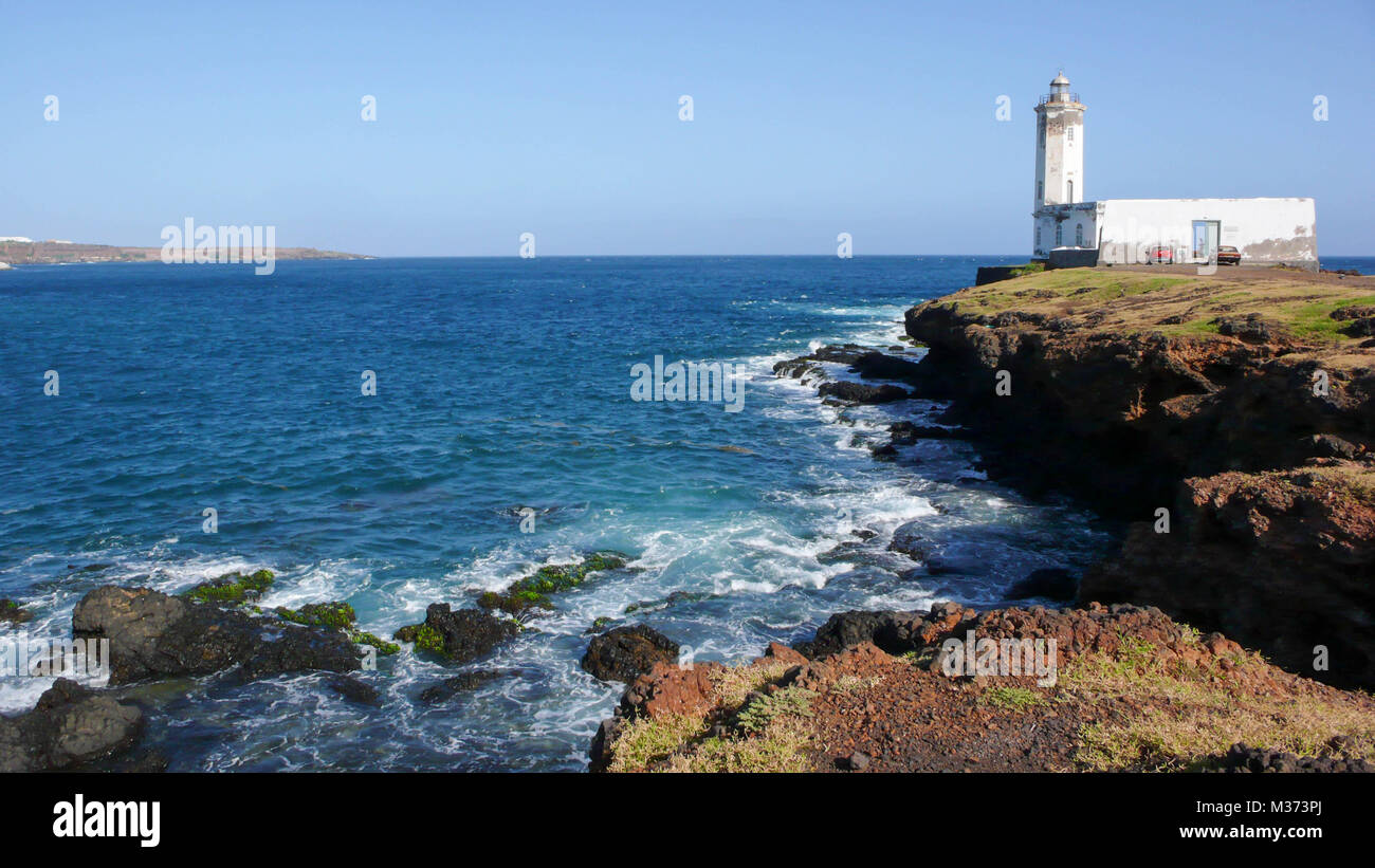 white lighthouse on a rocky point on the Atlantic Ocean in the Cape ...
